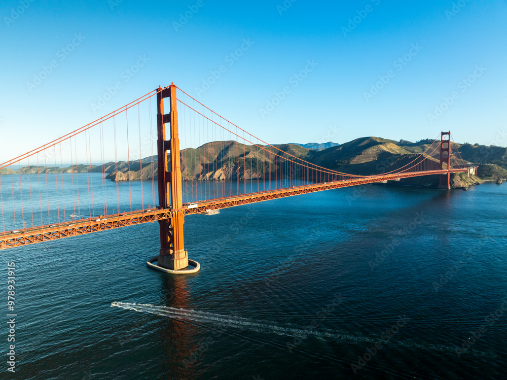 Aerial view of the iconic golden gate bridge spanning the ocean under a ...