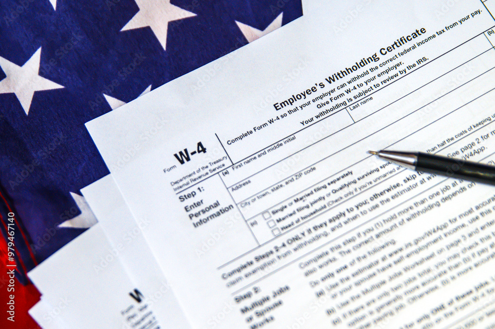 W4 Form Employee's Withholding Certificate with pen and American flag ...
