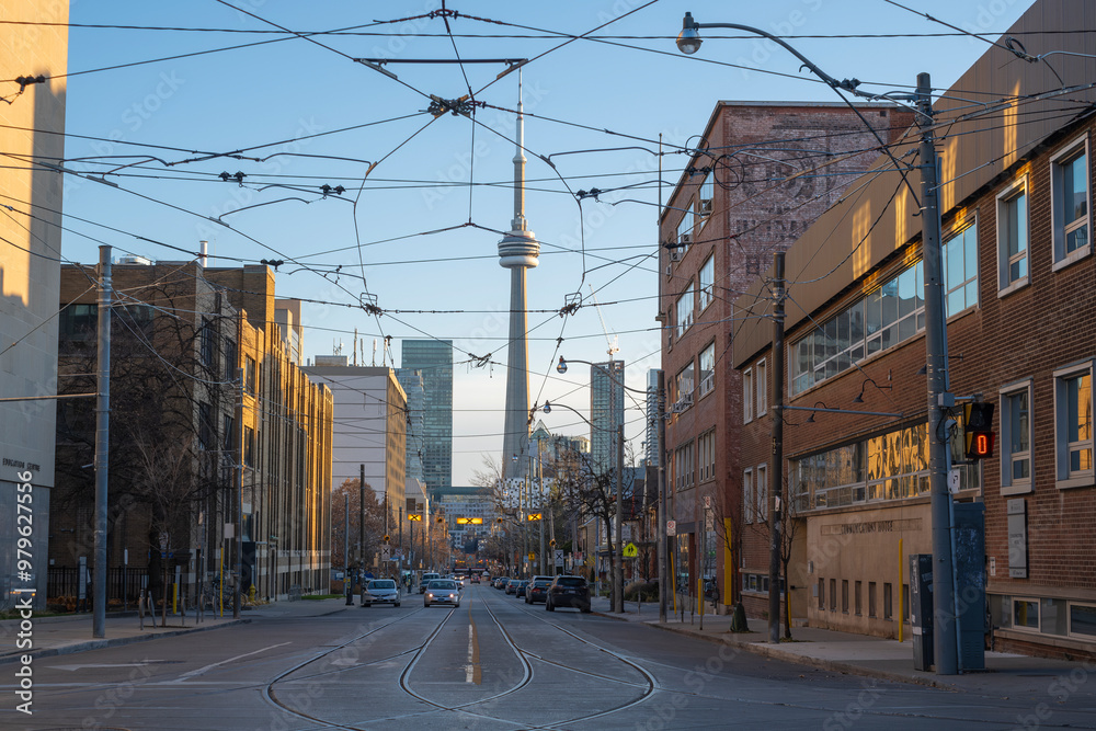Busy downtown street with web of streetcar wires, CN Tower and high ...