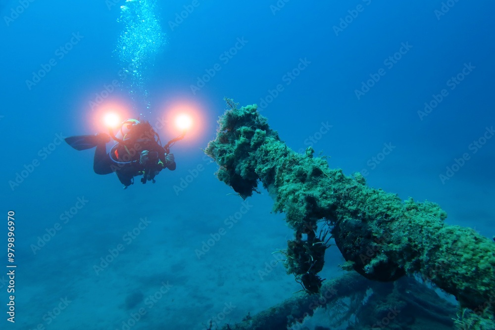 Scuba diver and part of the wreck. Scuba diving trip, wreck exploration ...