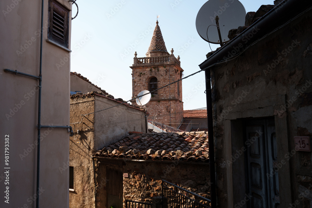 View of rustic village rooftops with a historic bell tower in the ...
