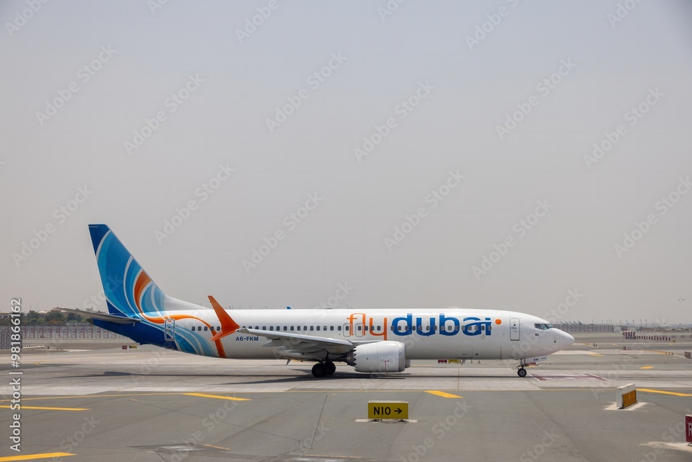 DUBAI, UAE - CIRCA 2024: A flydubai airplane taxiing on the runway at ...