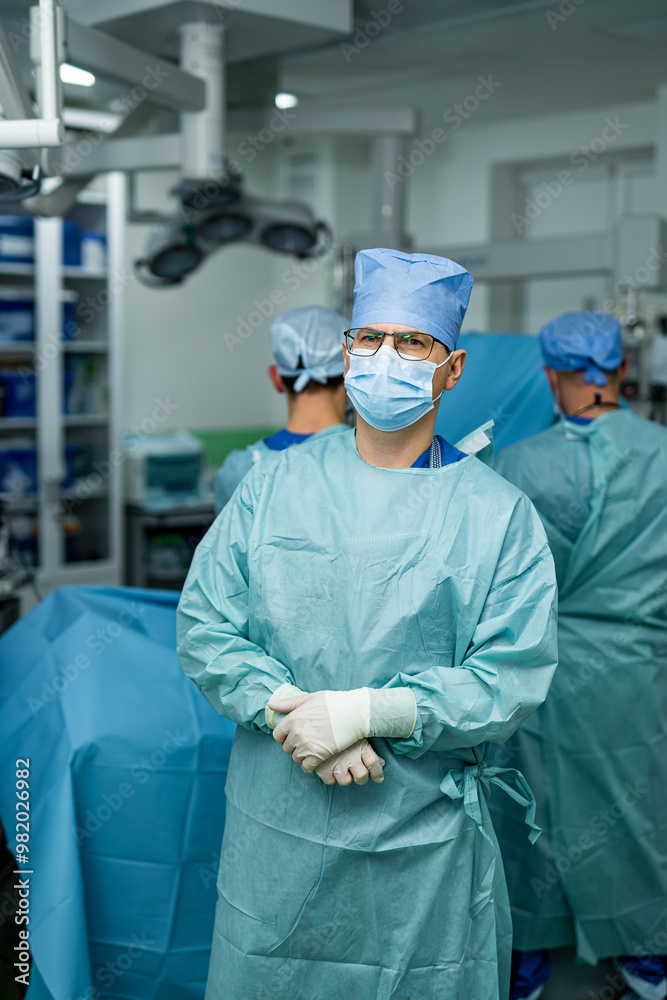 Surgical team preps in sterile room. A surgical team in scrubs and ...