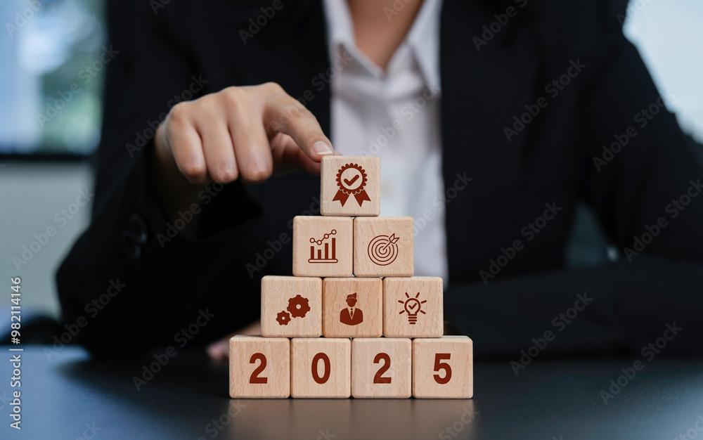 Businesswoman holding wooden blocks with award icon on wood cube block ...