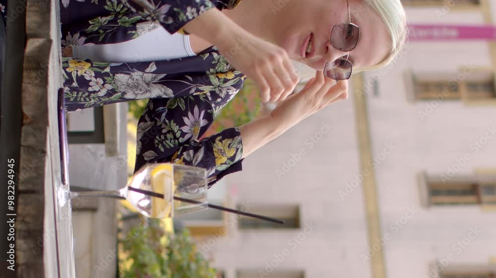 Blonde woman expresses surprise during outdoor conversation. Her facial ...