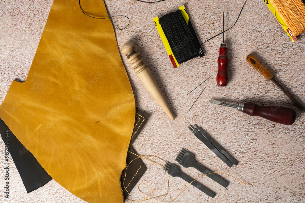 Tanner's workbench. Tools and leather on the tanner's workbench. A set ...