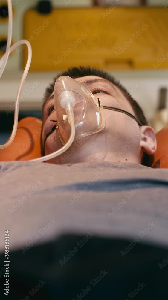 Vertical video. Patient, paramedic and blood pressure with oxygen mask ...