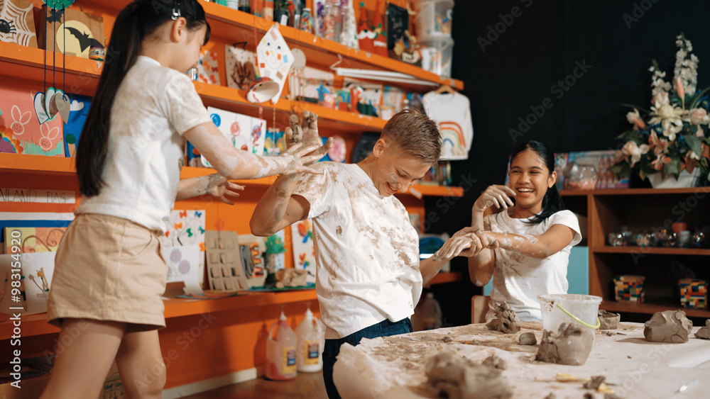 Diversity happy student playing clay while put on shirt at art lesson ...