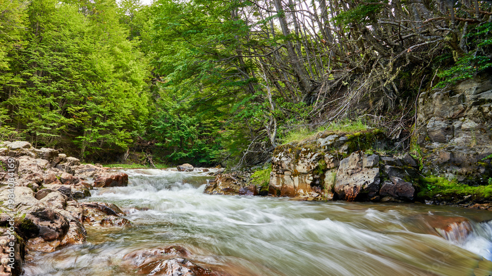 Cascada Río Pipo flows through a rocky landscape surrounded by lush ...