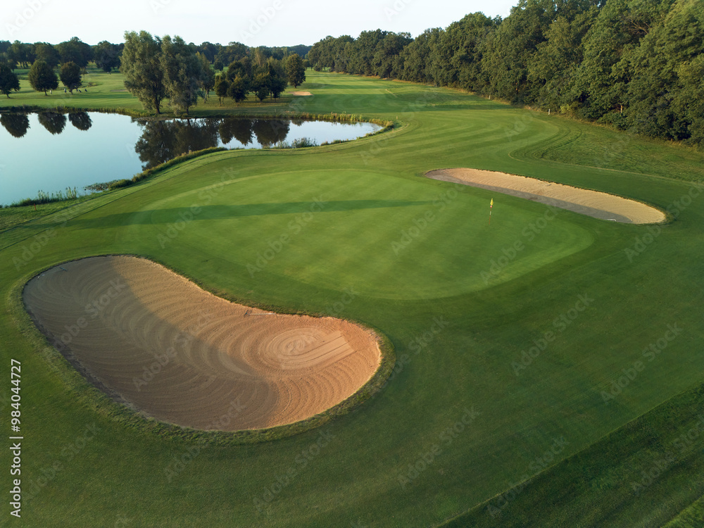 Stunning lakeside golf green with bunkers with vibrant green and well ...