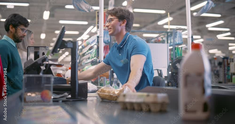 Young Cashier Working at a Supermarket Checkout. Worker Scanning ...