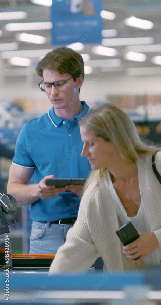 Vertical Footage: Store Manager Helping Female Shopper to Use a Self ...