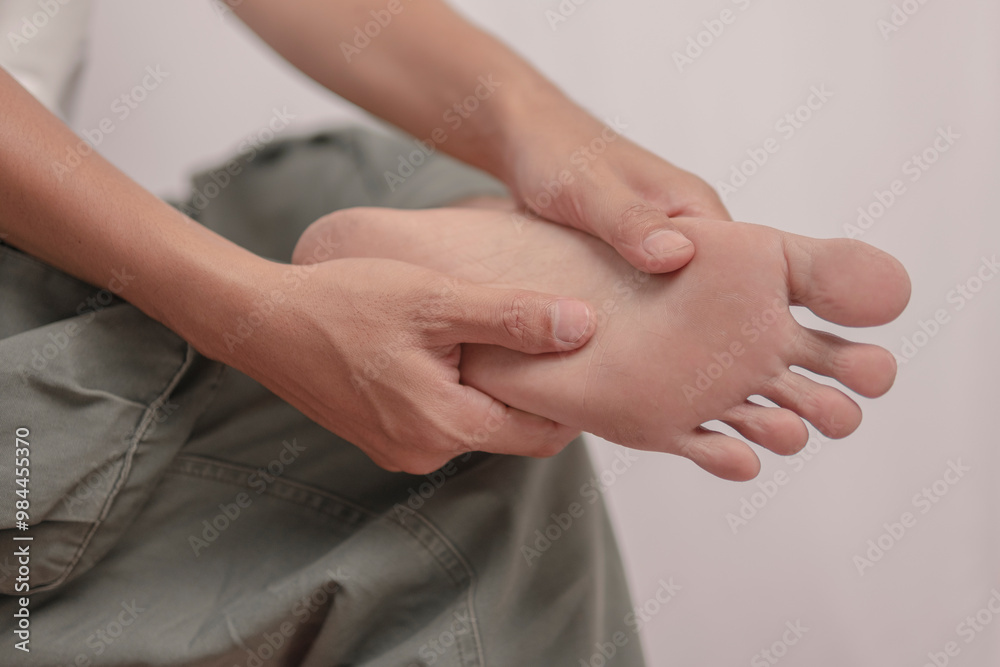 Inflammation of the ankle held by hand. Pain attacks a young man's ...