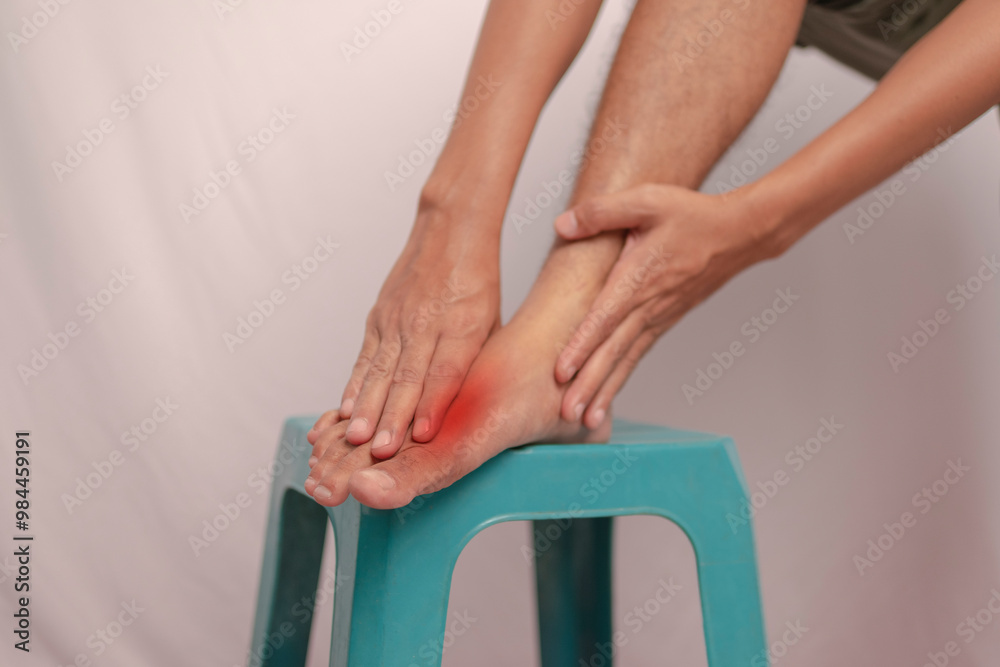Inflammation of the joints in the feet held by the hands. Pain ...