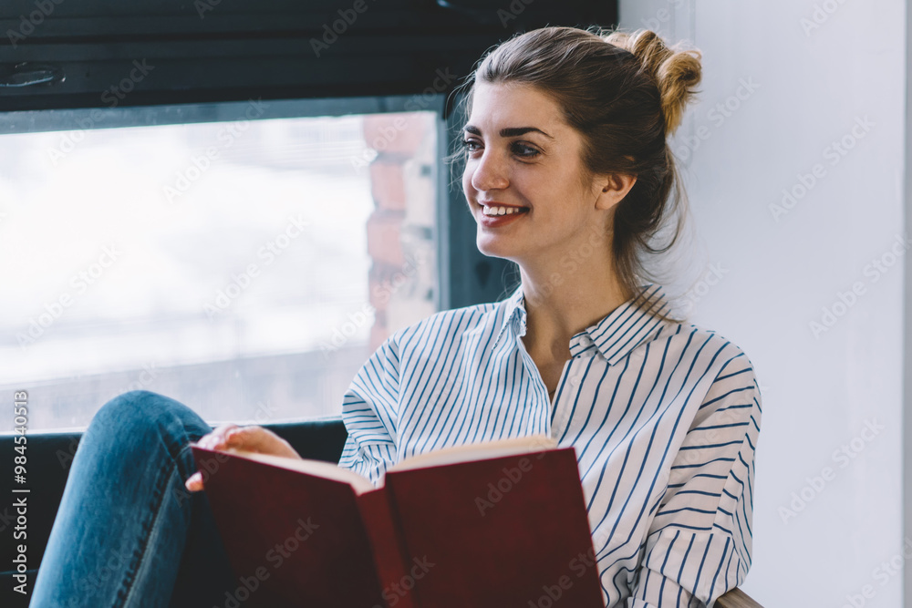 Happy successful female reader with interesting positive literature ...