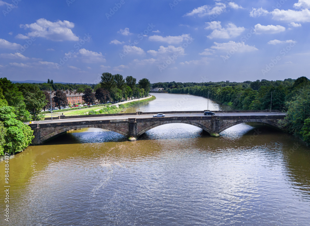 low level aerial view of the old stone arched bridge over the River ...