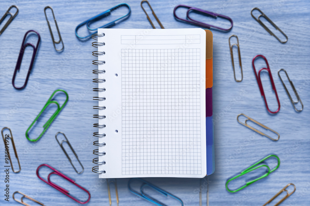 Notepad page. Open notepad on desktop background with scattered paper ...