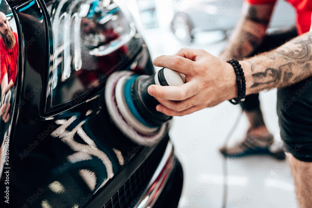 Professional vehicle polishing and detailing service in a modern car ...