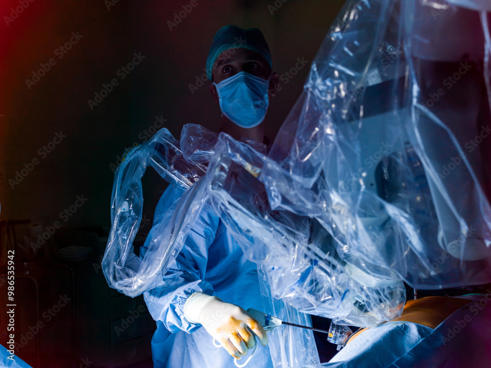 surgeon performing robotic surgery with robotic device. Medical ...