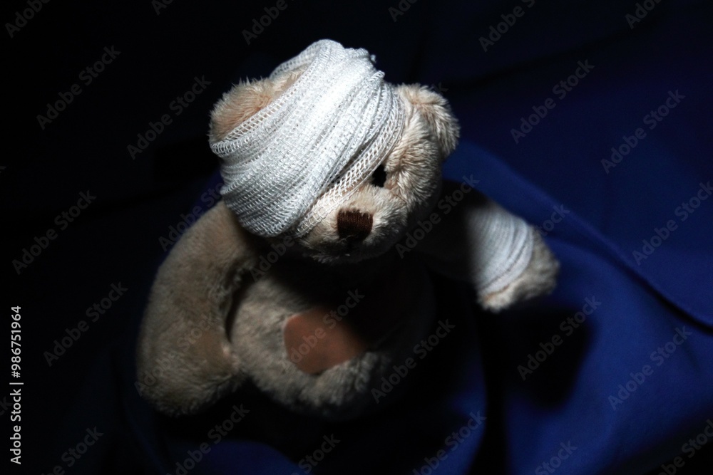 Injured sick teddy bear bandaged with bandage and plaster. Trauma that ...
