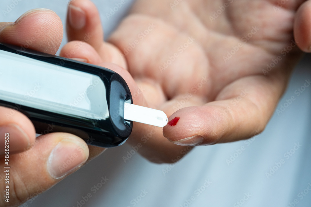 hand of people check diabetes and high blood glucose monitor with ...