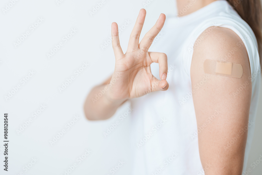 Woman with bandage after receiving vaccine. Vaccination and ...