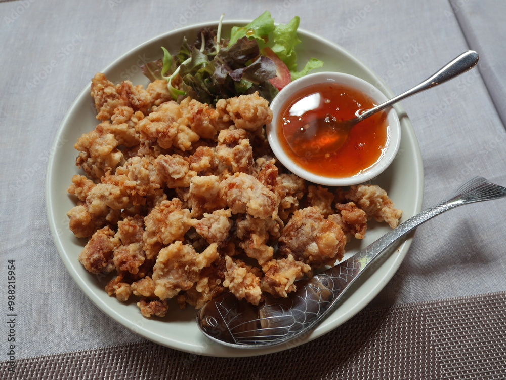Pile of deep fried Chicken tendons dressing with sesame serving on the ...