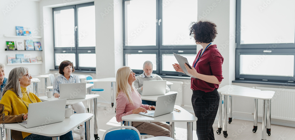 Teacher explaining senior students how to start their own business ...