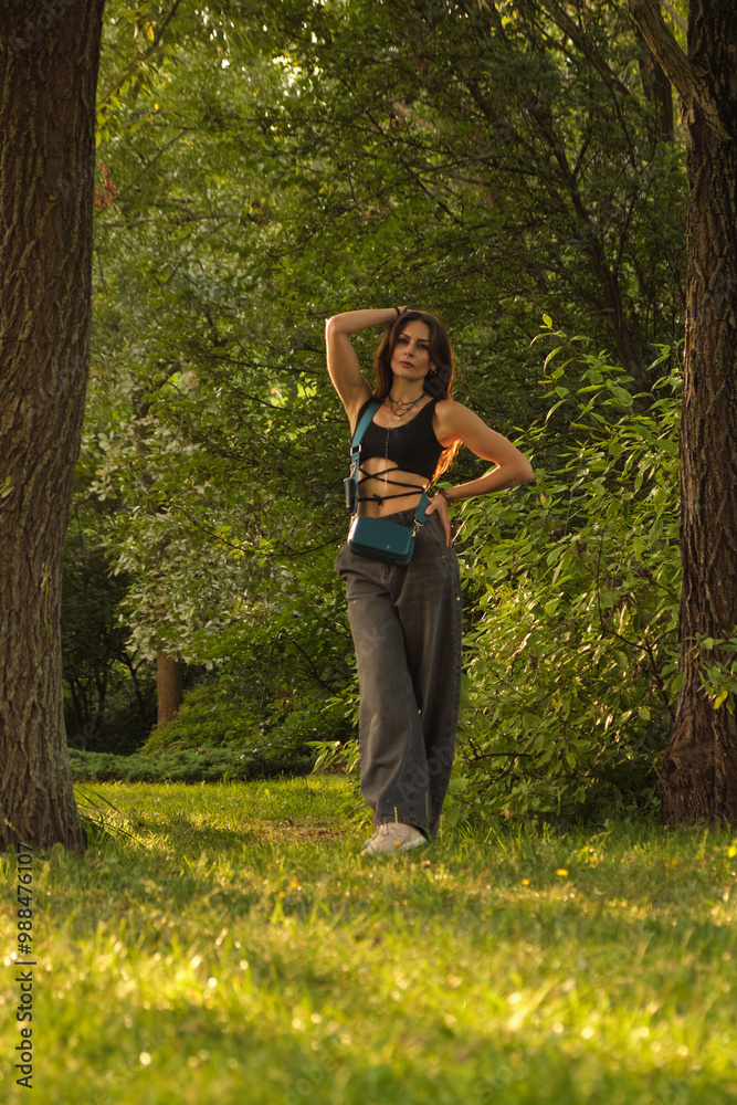 Woman standing tall with arms lifted, embracing the natural beauty of a ...