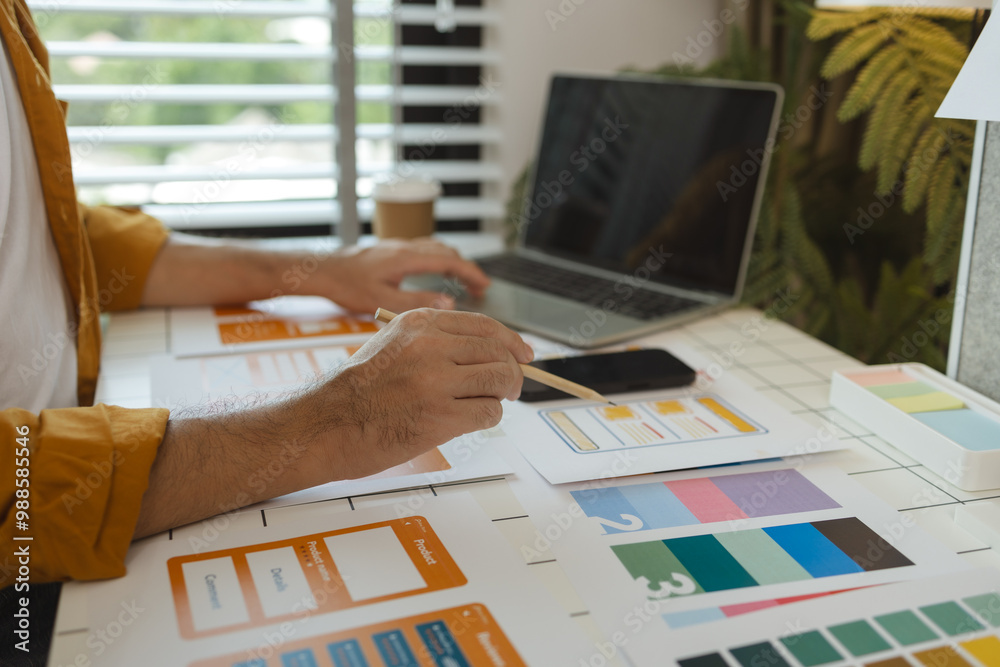 A web designer is using his idea to create a digital product design ...