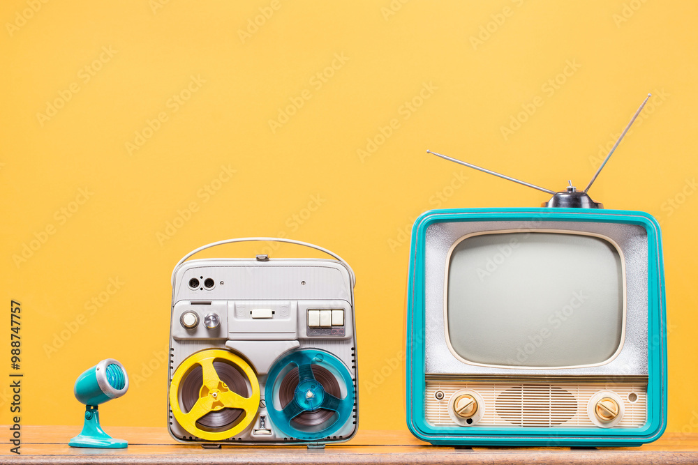 Retro TV, reel to reel tape recorder and microphone front yellow ...
