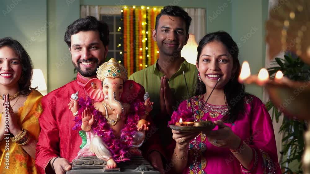 Indian family dressed in traditional attire,joyfully welcomes Ganapati ...