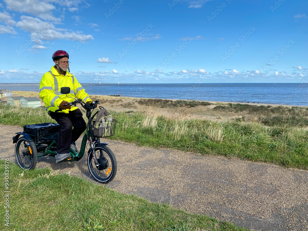 South Asian senior disabled male in yellow high visibility jacket and ...