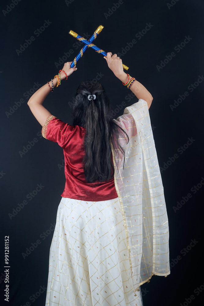 Elegance in Motion: Young Indian Girl Poised for Dandiya Dance in ...