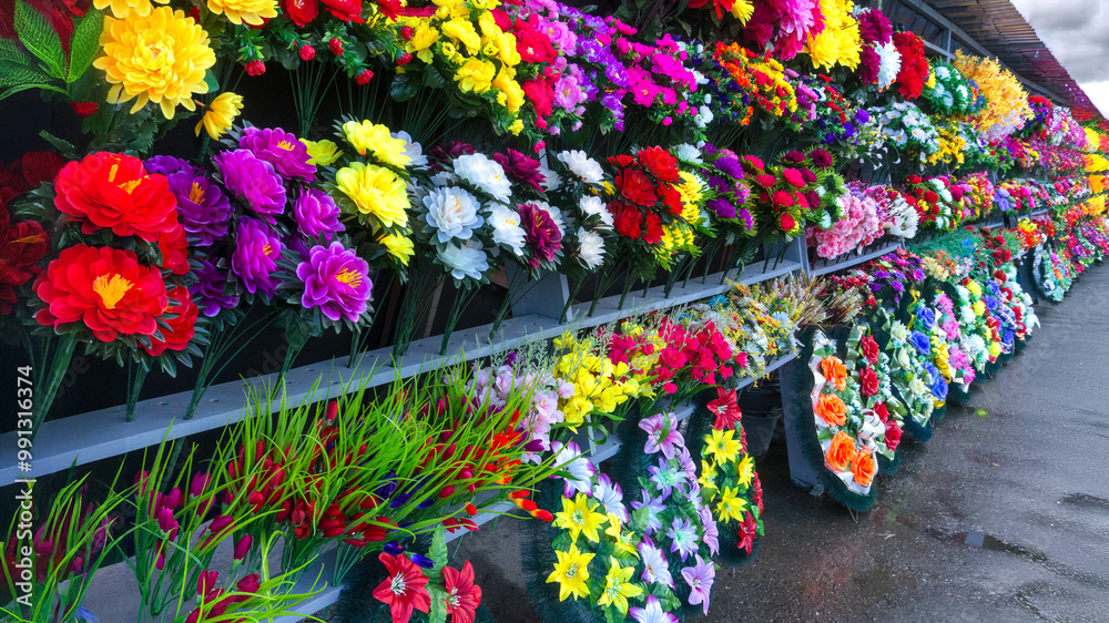 Funeral bouquets of plastic flowers rows, symbols of respect and memory ...