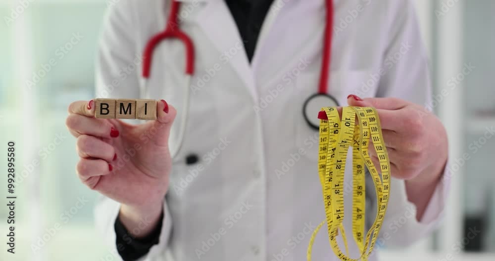 Doctor holds word BMI from wooden blocks and measuring tape to measure ...