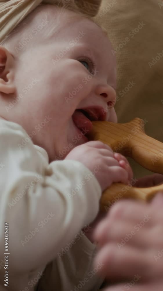 Vertical close-up of adorable baby girl wearing cute headband lying on ...