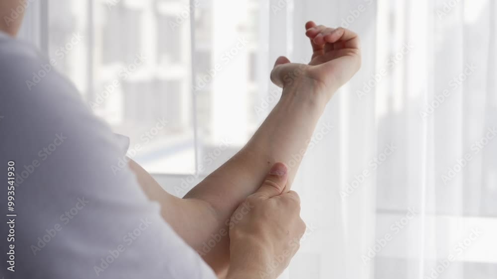 A man strokes his outstretched hand. Male hand on a white background. A ...
