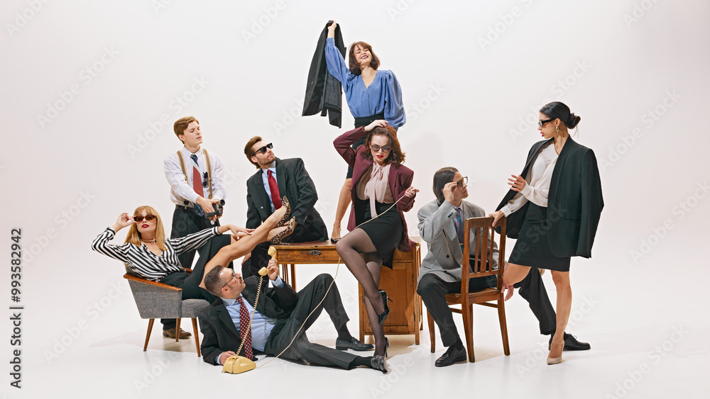 Quirky office scene unfolds as eight employees, dressed in business ...