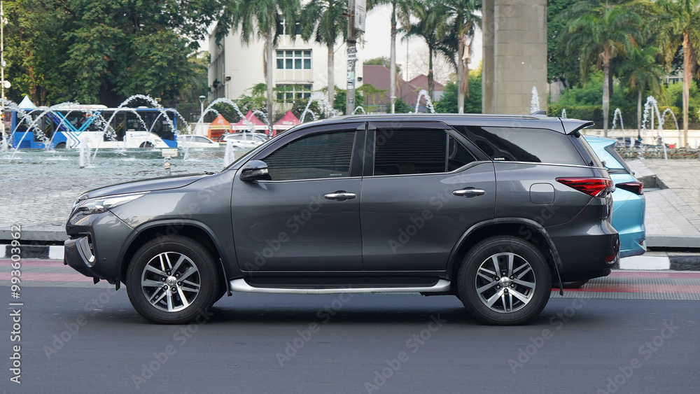 Day Gray Doff color, SUV Toyota Fortuner, drive at comercial area ...