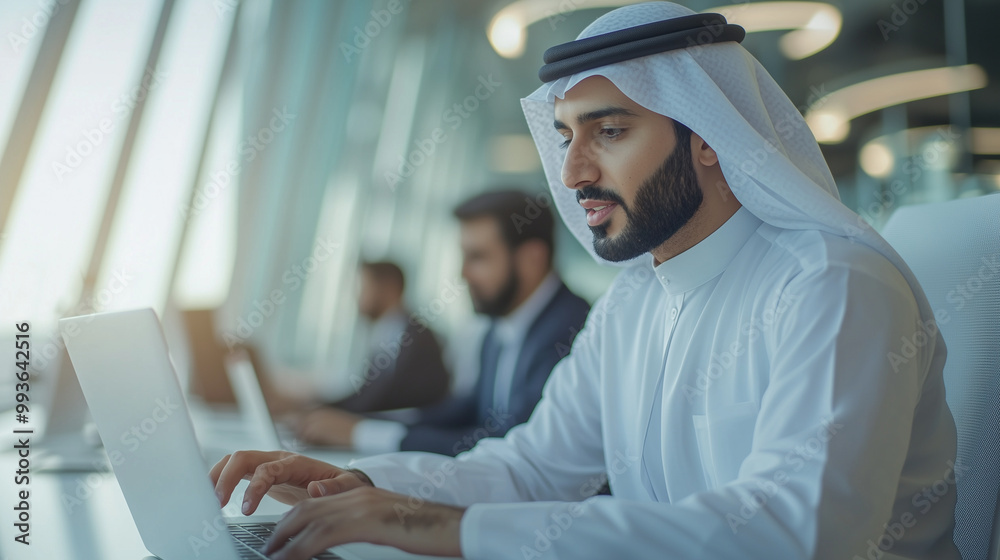 A group of young Middle Eastern professionals in Arab attire gathered ...