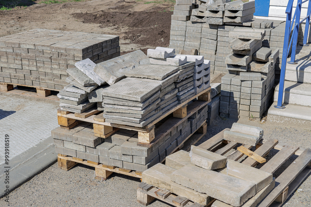 An organized arrangement of concrete blocks stacked on wooden pallets ...