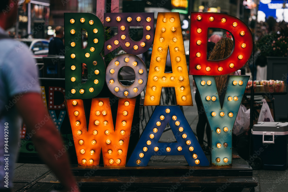 Colorful lit Broadway sign in Times Square, New York City street scene ...