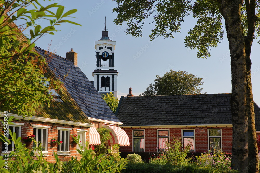 raditional houses and the clock tower of the reformed church (Hervormde ...