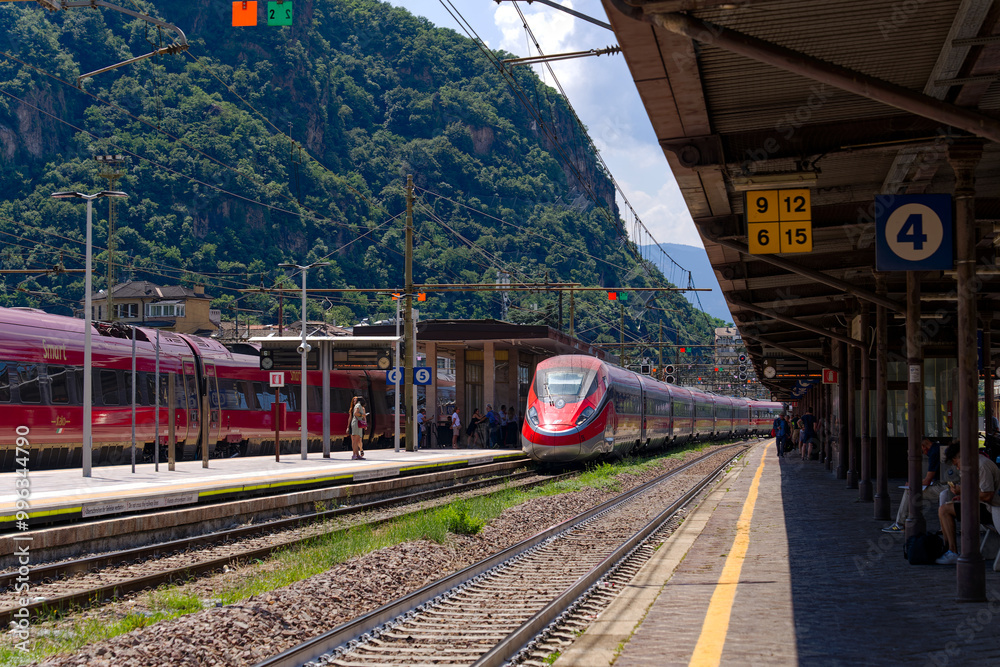 Red and silver colored high speed train named Frecciarossa arriving at ...