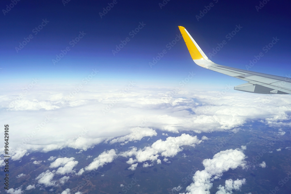 Flying above the clouds: cloudy sky and airplane wing photographed from ...