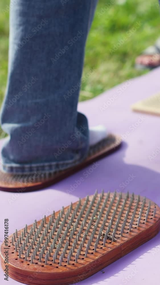 Standing on sadhu board, process of barefoot standing on nails therapy ...