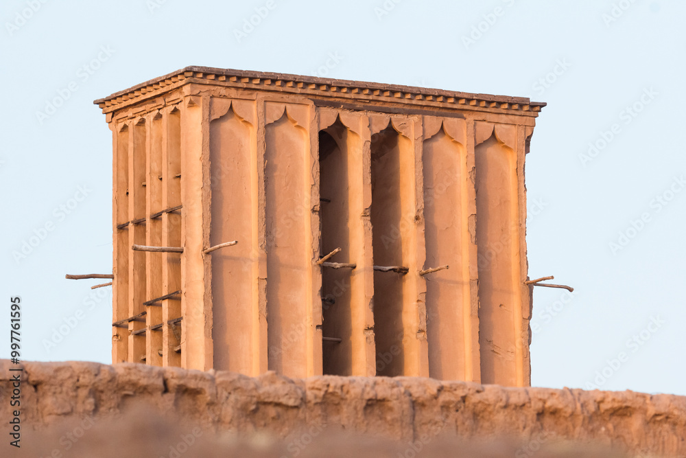 An antique wind catcher made with adobes is a structure to cool down ...