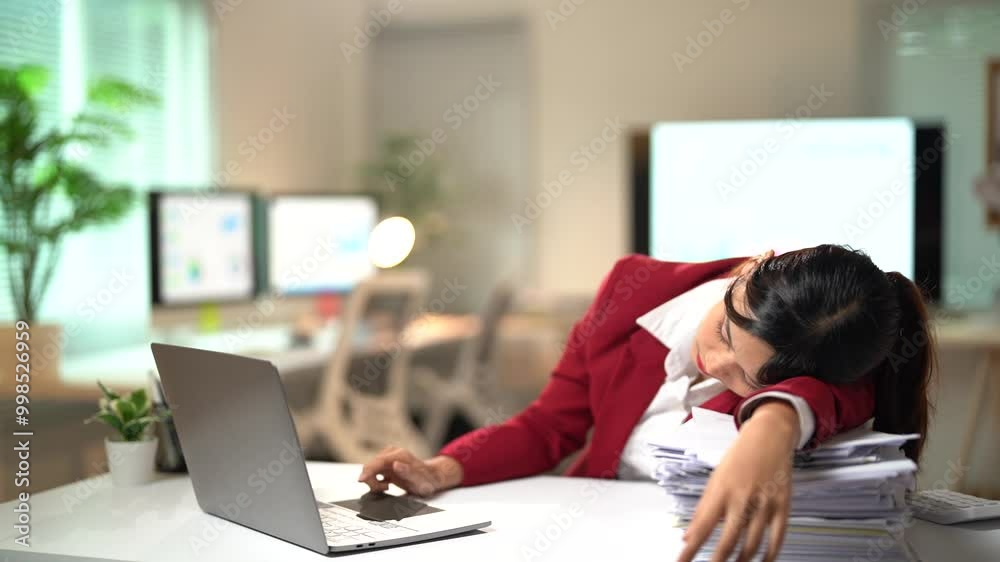 Businesswoman is slowly falling asleep at her desk while working on her ...