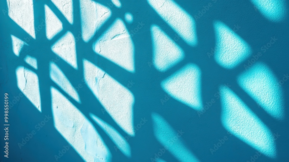 Shadow overlay of abstract patterns on a pastel blue wall background ...